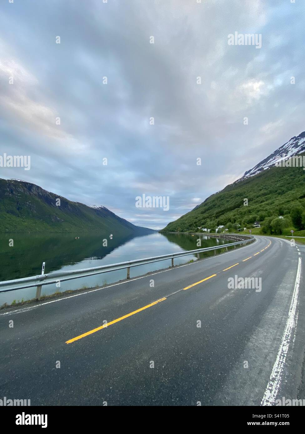 Wet asphalt road in Beisfjord, Nordland, Northern Norway in a cloudy ...