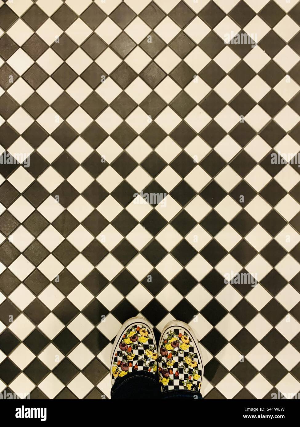 Checkered shoes on checkered floor Stock Photo - Alamy