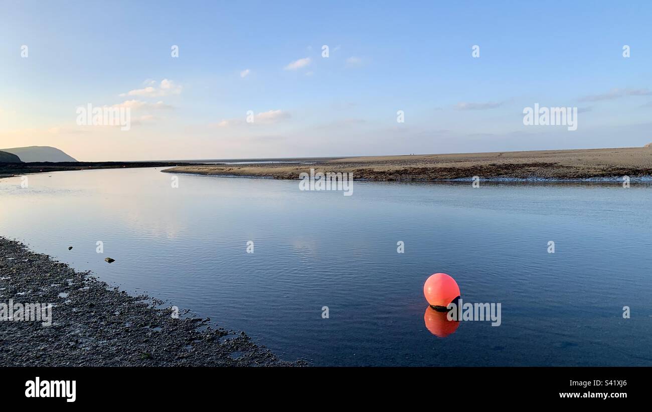 Pink buoy on calm serene estuary Stock Photo - Alamy