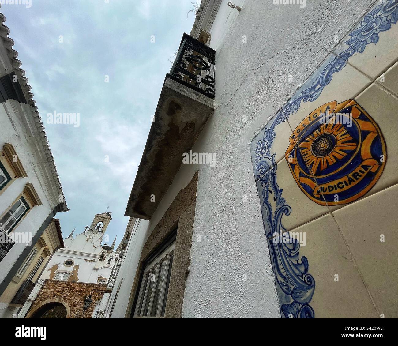 Behind the Arco da Vila gate in Faro the police station has a tiled ...