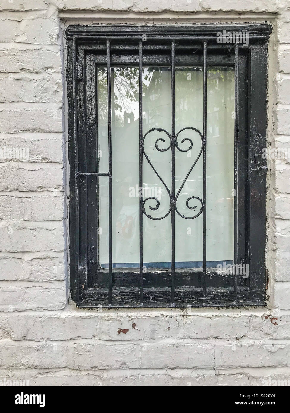 Ironwork window in whitewash brick wall Stock Photo - Alamy