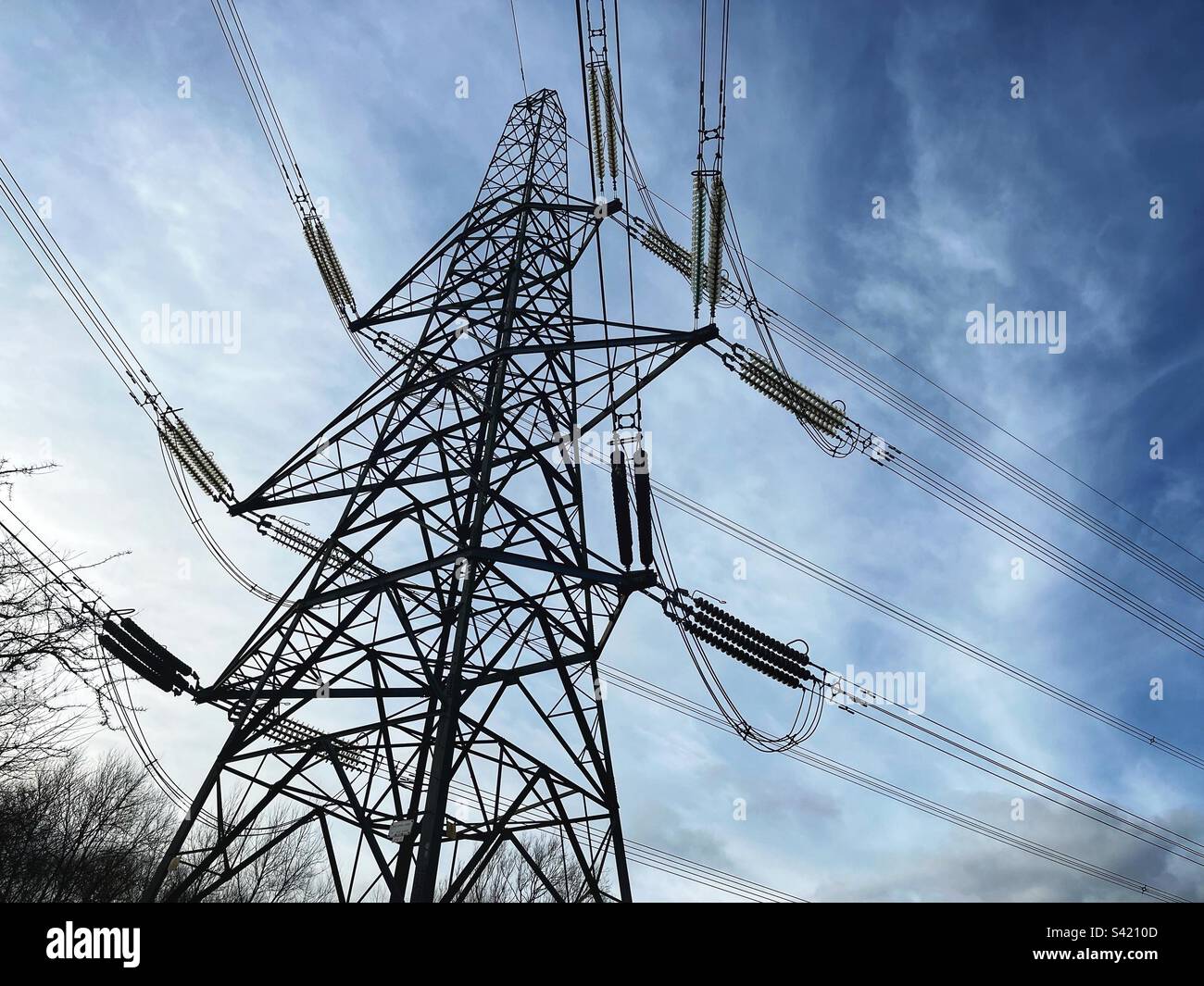 An electricity pylon is seen from below in the Oxfordshire countryside ...