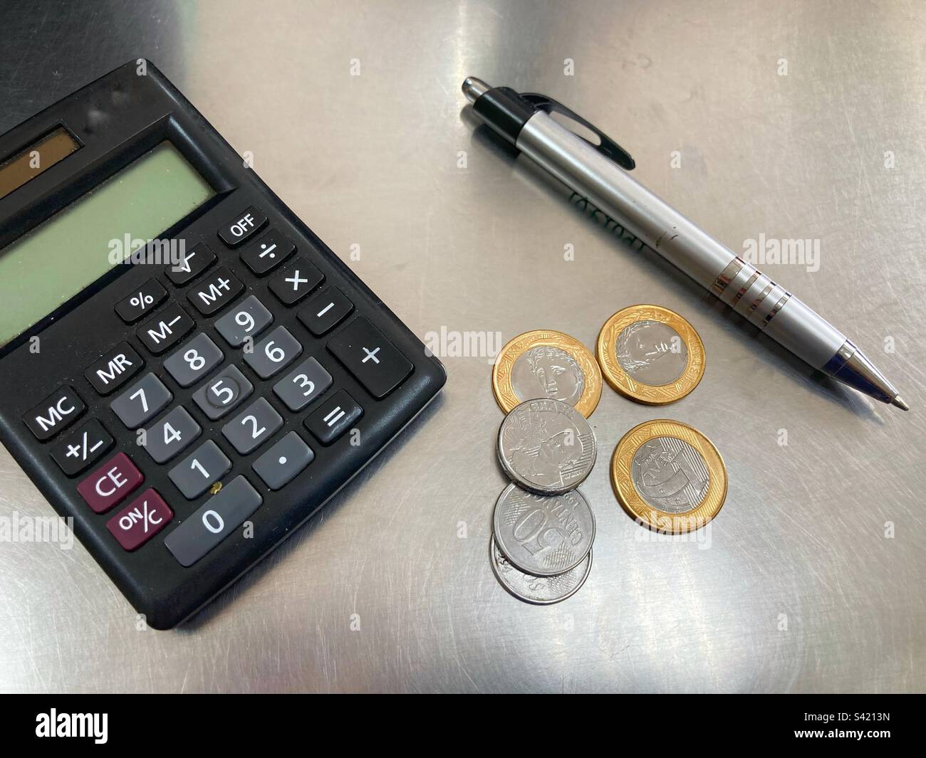 Calculator with coins hi-res stock photography and images - Alamy