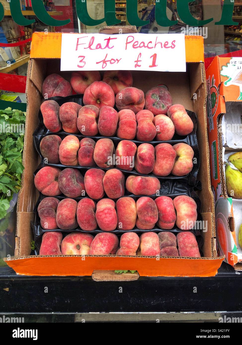 Ripe Flat peach’s priced up for sale at local grocery Stock Photo - Alamy
