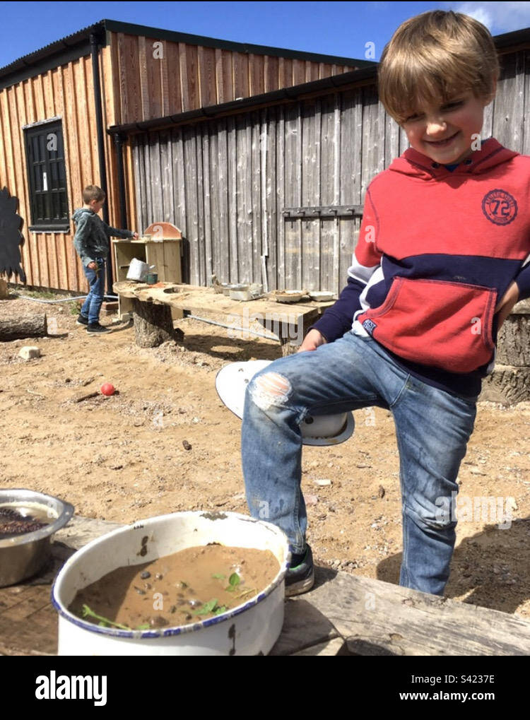 Young boys in mud kitchen Stock Photo - Alamy