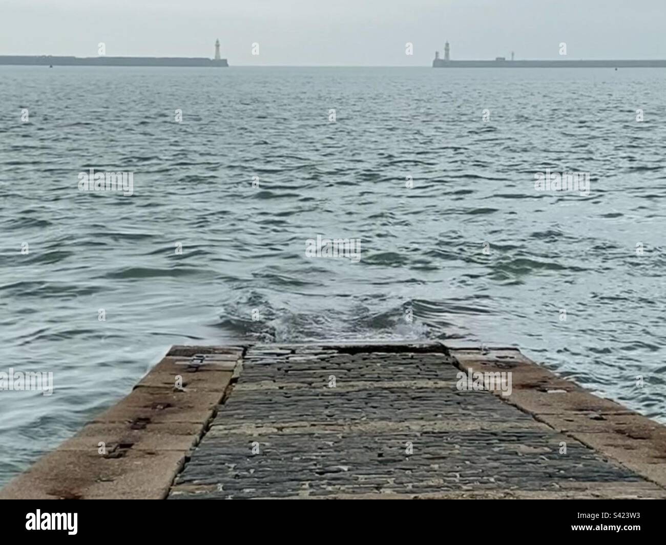 Start of a journey. End of a sea jetty pointing out through the the ...