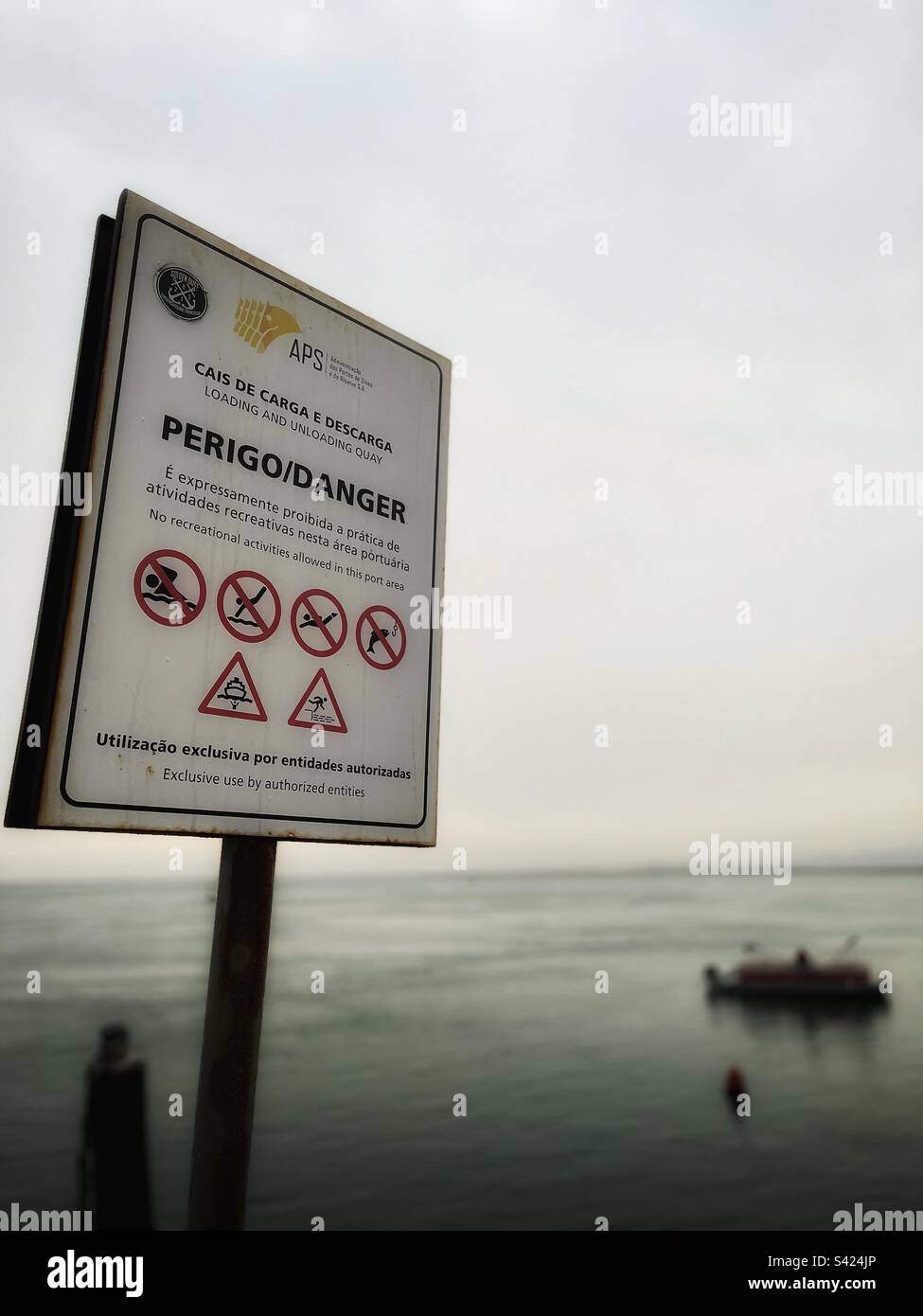 Perigo Danger sign on the beach in Portugal in Portuguese and English ...