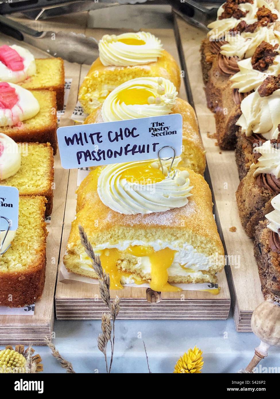 White Chocolate Passion Fruit Swiss in bakery window display Stock ...
