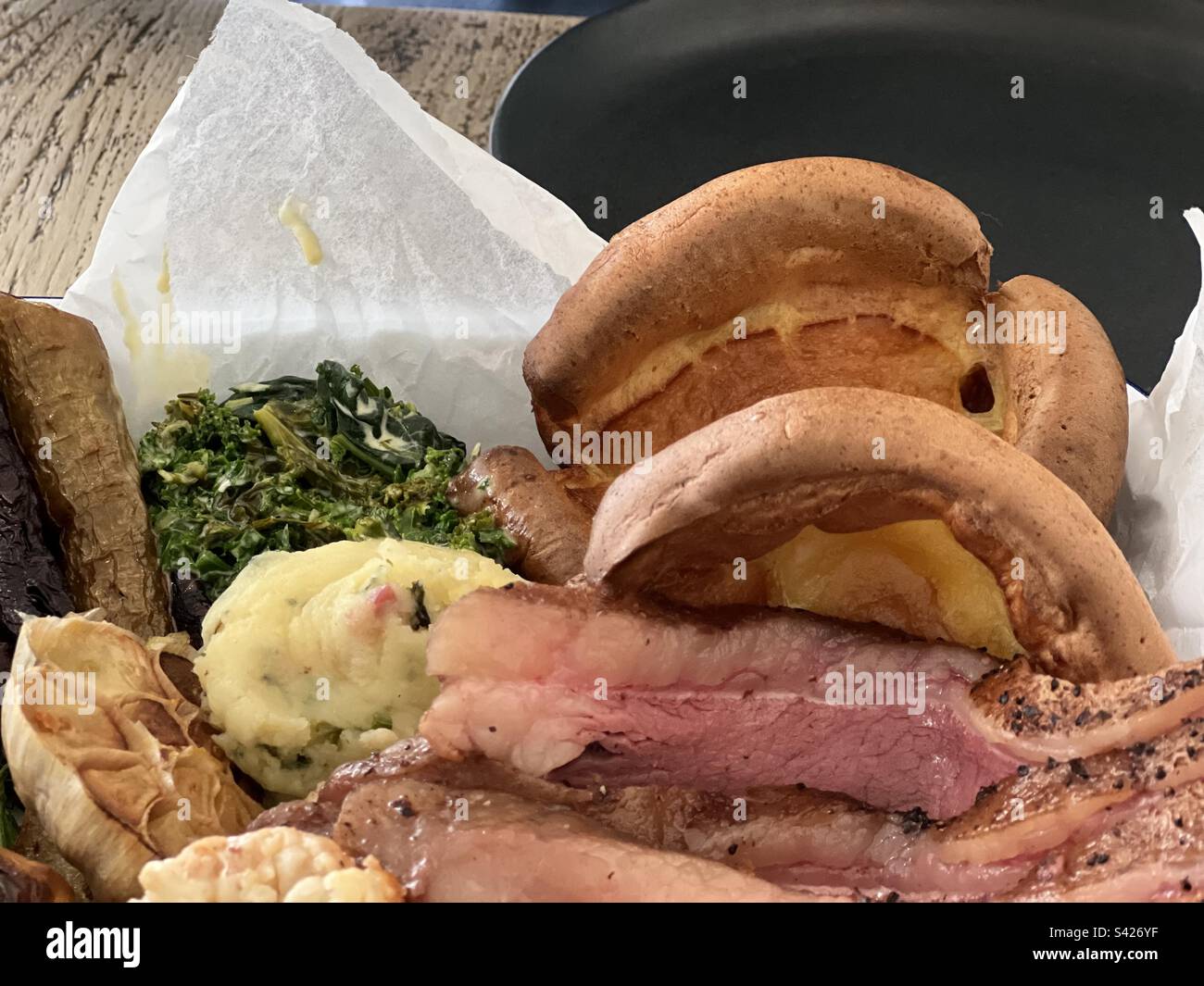 Sharing beef with Yorkshire puddings, creamed cabbage, roasted garlic ...