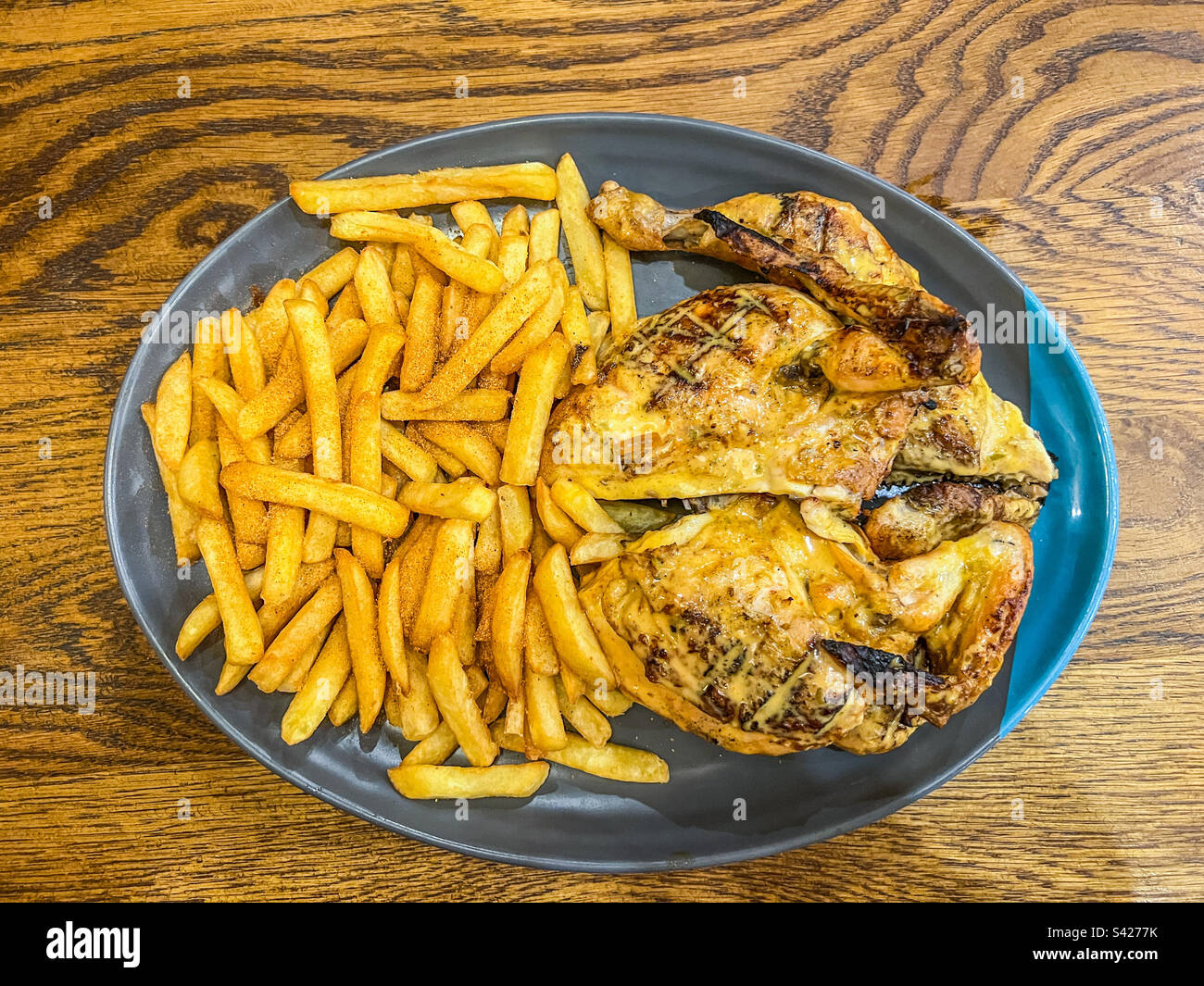 Nando’s whole peri peri chicken and seasoned chips Stock Photo - Alamy