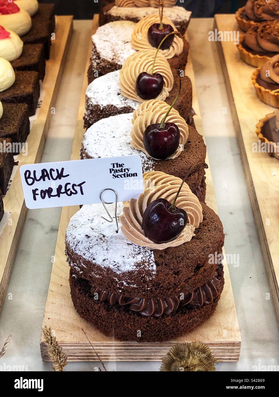 Black Forest cake in bakery shop window Stock Photo - Alamy