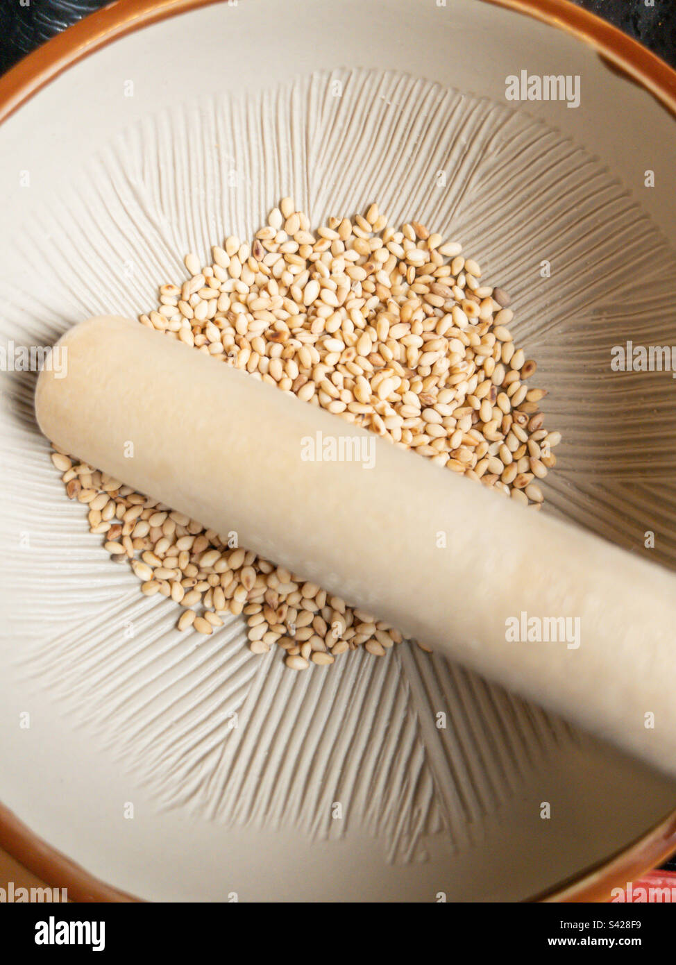 Japanese pestle and wooden mortar with sesame seeds Stock Photo - Alamy