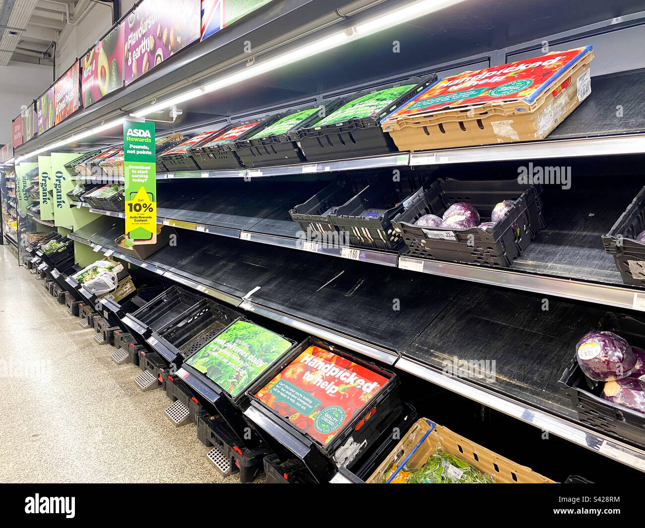 Empty shelves and the fresh fruit and veg aisle in a UK supermarket ...