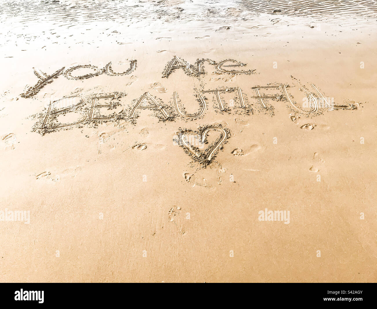 Message in the sand Stock Photo - Alamy