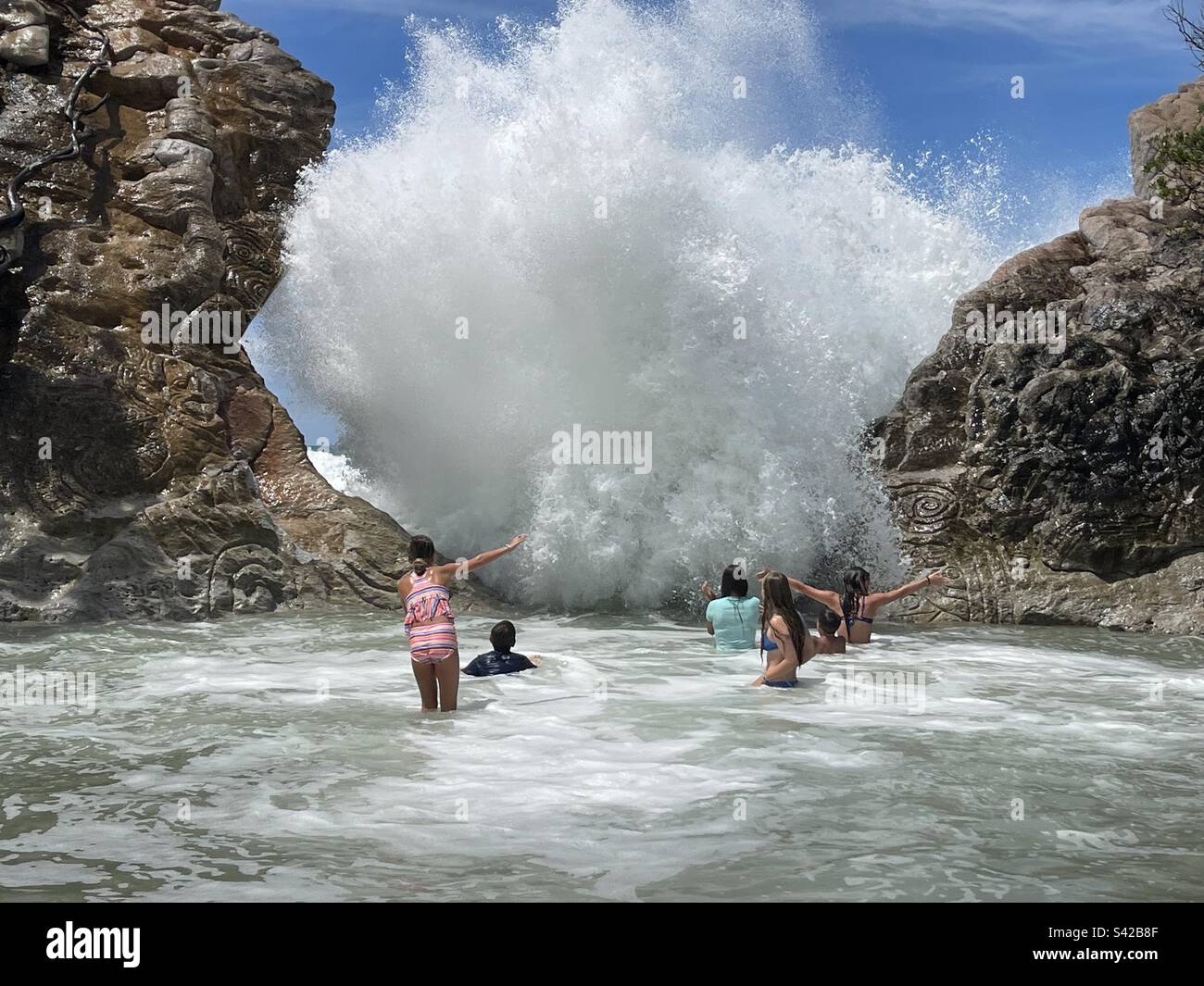 Waves crash through The Gap at Whiritoa beach Stock Photo - Alamy