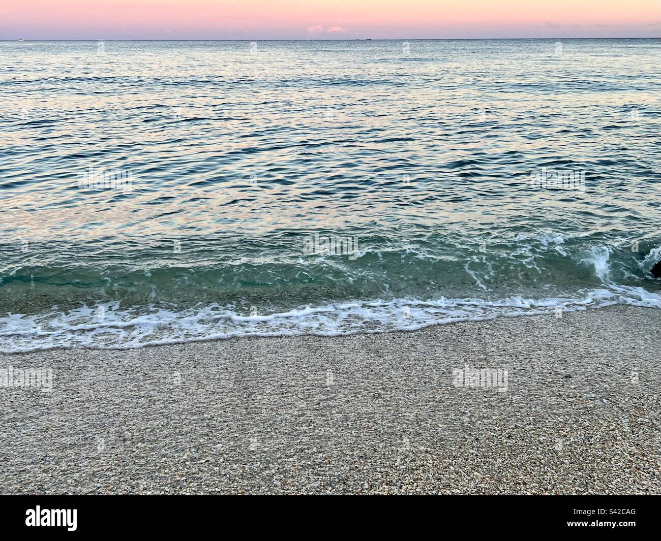 Low tide waves about to break at sunset in the east coast of Florida ...