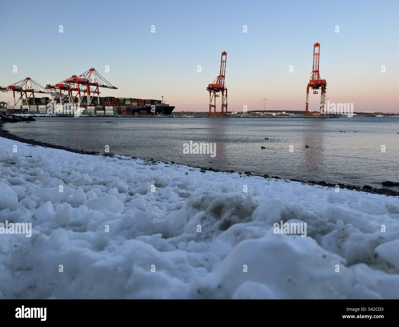Halifax sea port in winter: cargo ships docked at snowy pier amidst ...