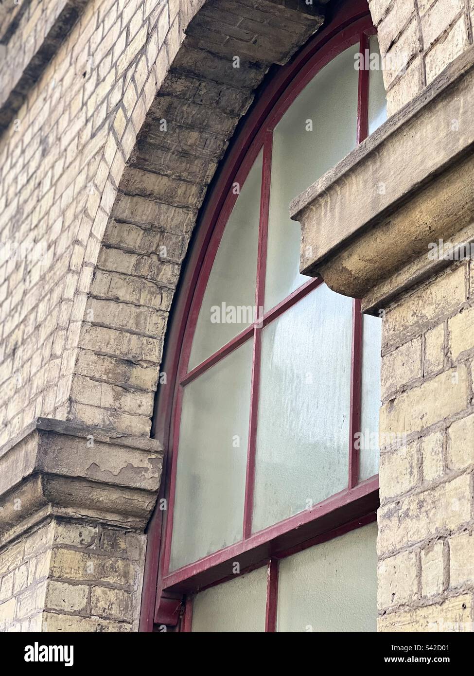 Brick arch frames London window Stock Photo - Alamy