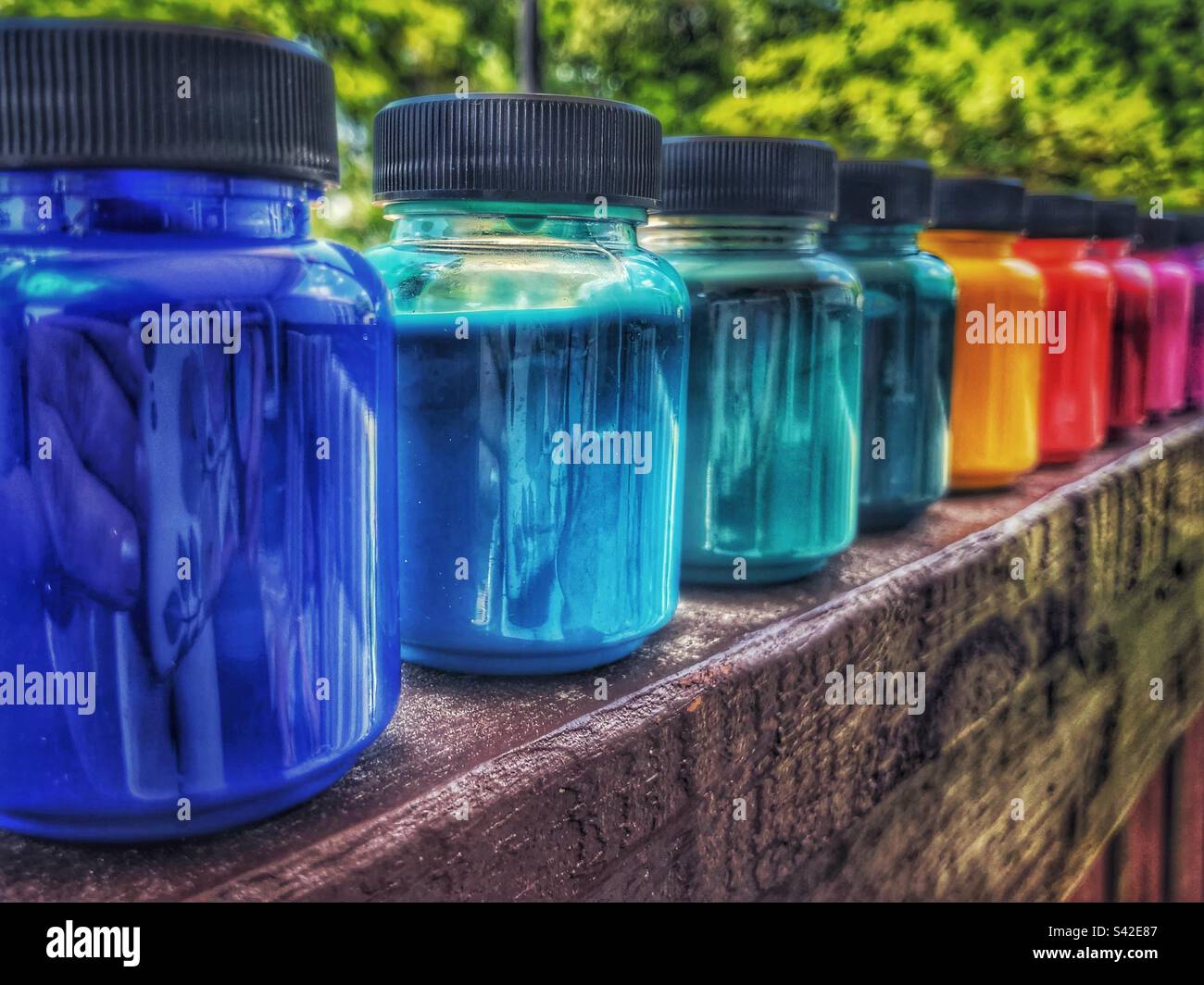 Paint jars in a row Stock Photo - Alamy