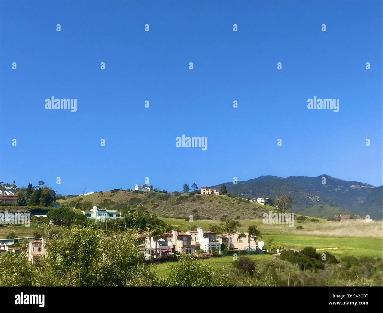 Vista of hills and mountain under a clear blue sky in Santa Barbara ...