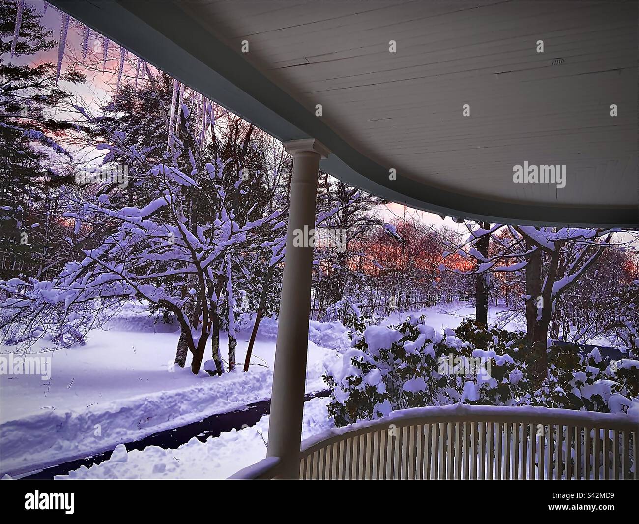 Victorian porch with view of snow and sunset sky Stock Photo - Alamy