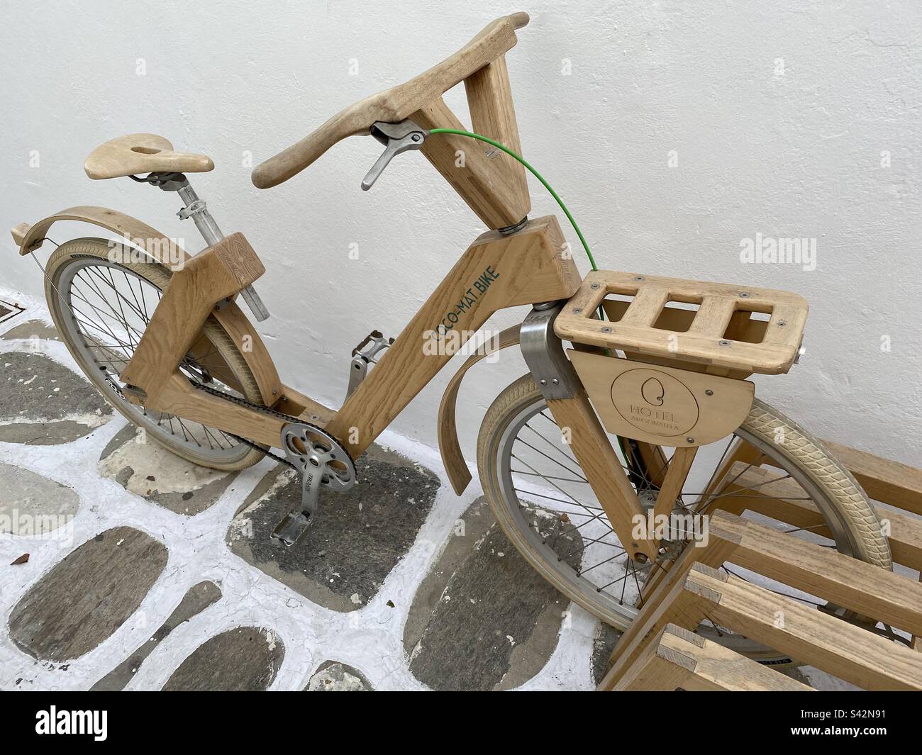 Wooden bicycle in wooden rack Stock Photo - Alamy