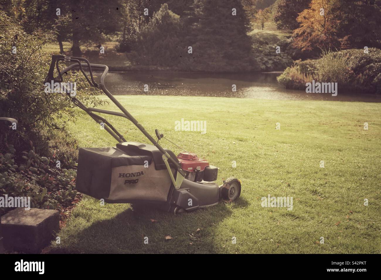 Image of a lawnmower in ornate gardens Stock Photo - Alamy