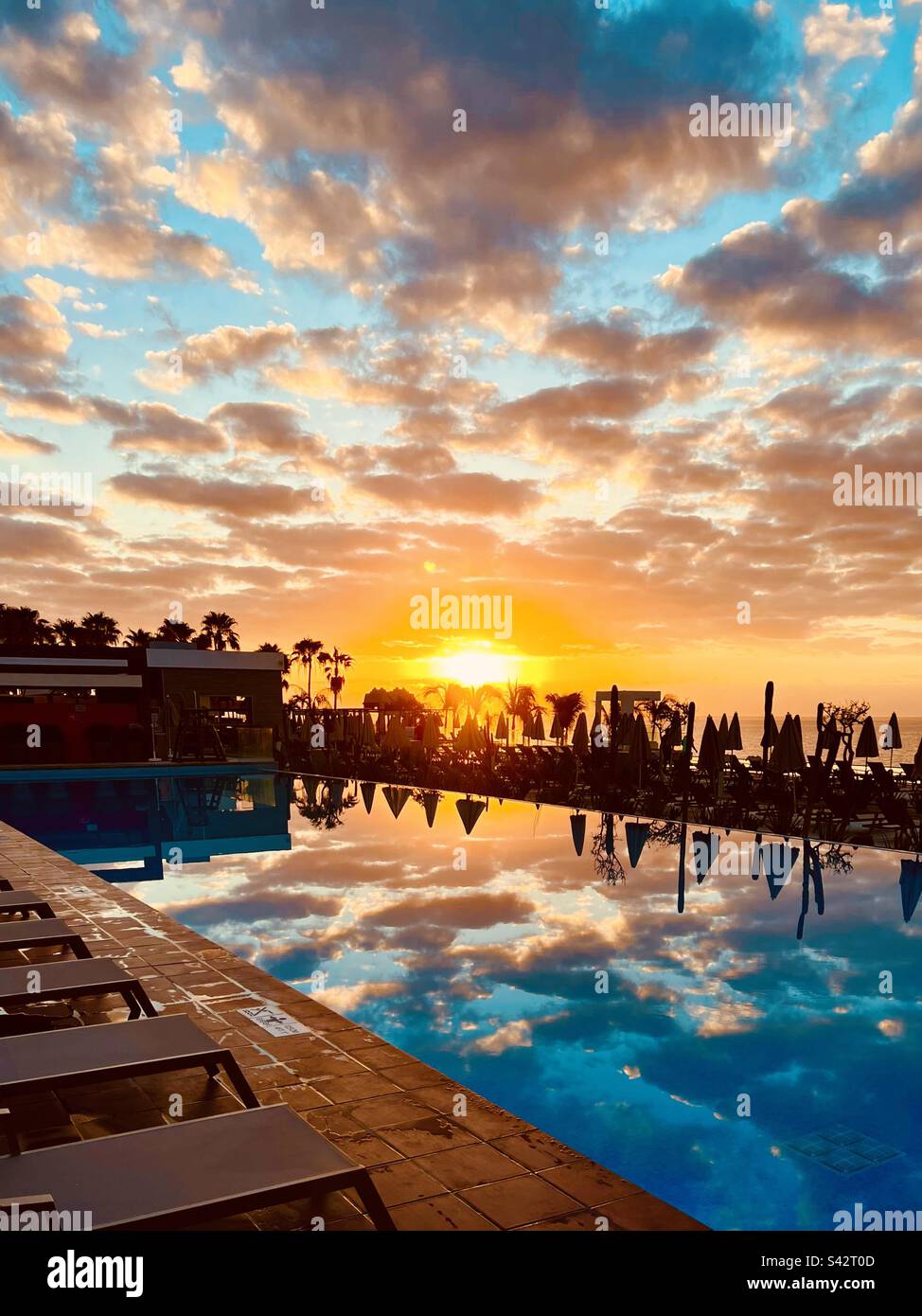 Sunrise over pool Stock Photo - Alamy