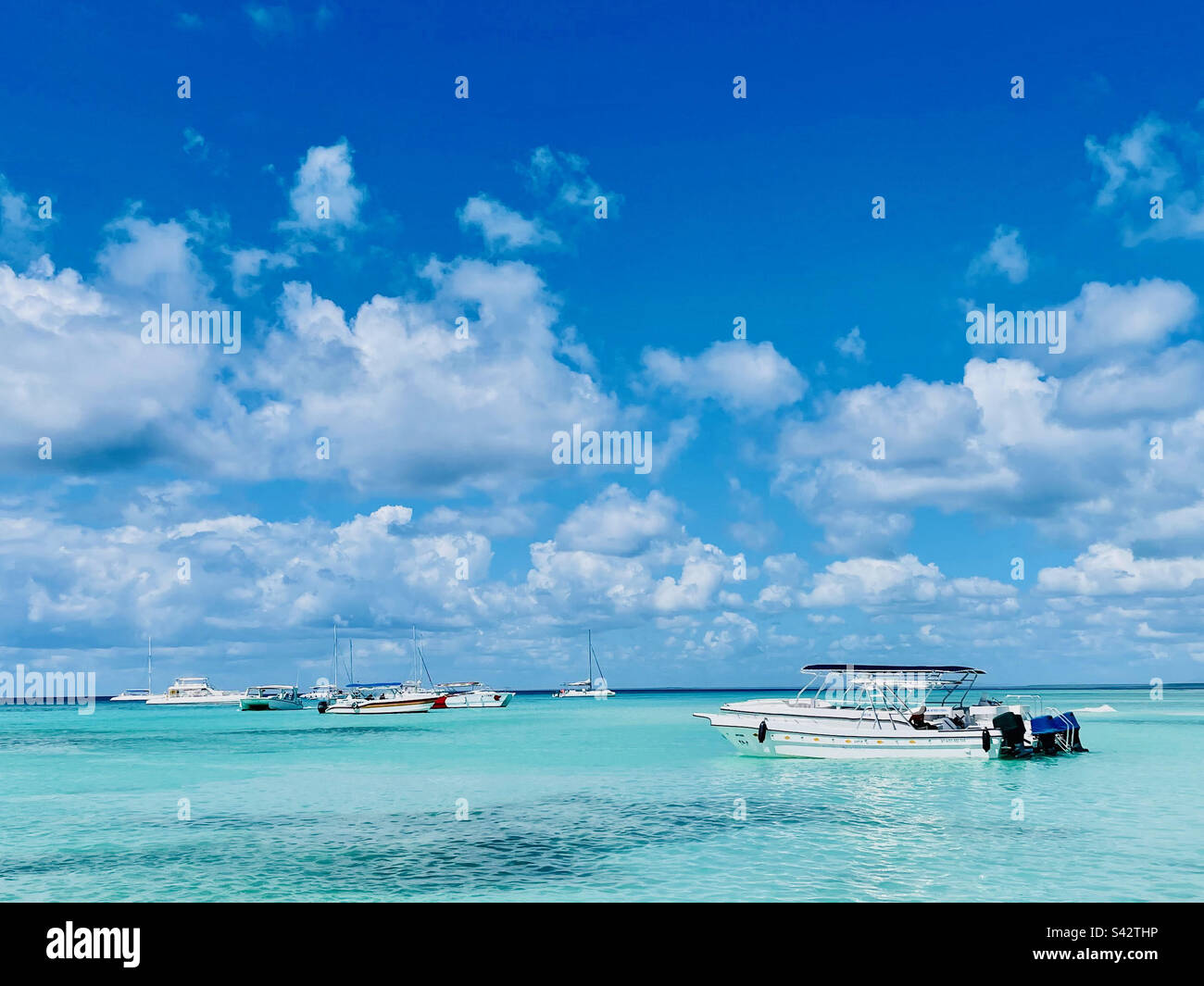 Caribbean beach scene with crystal blue water and blue sky with clouds ...