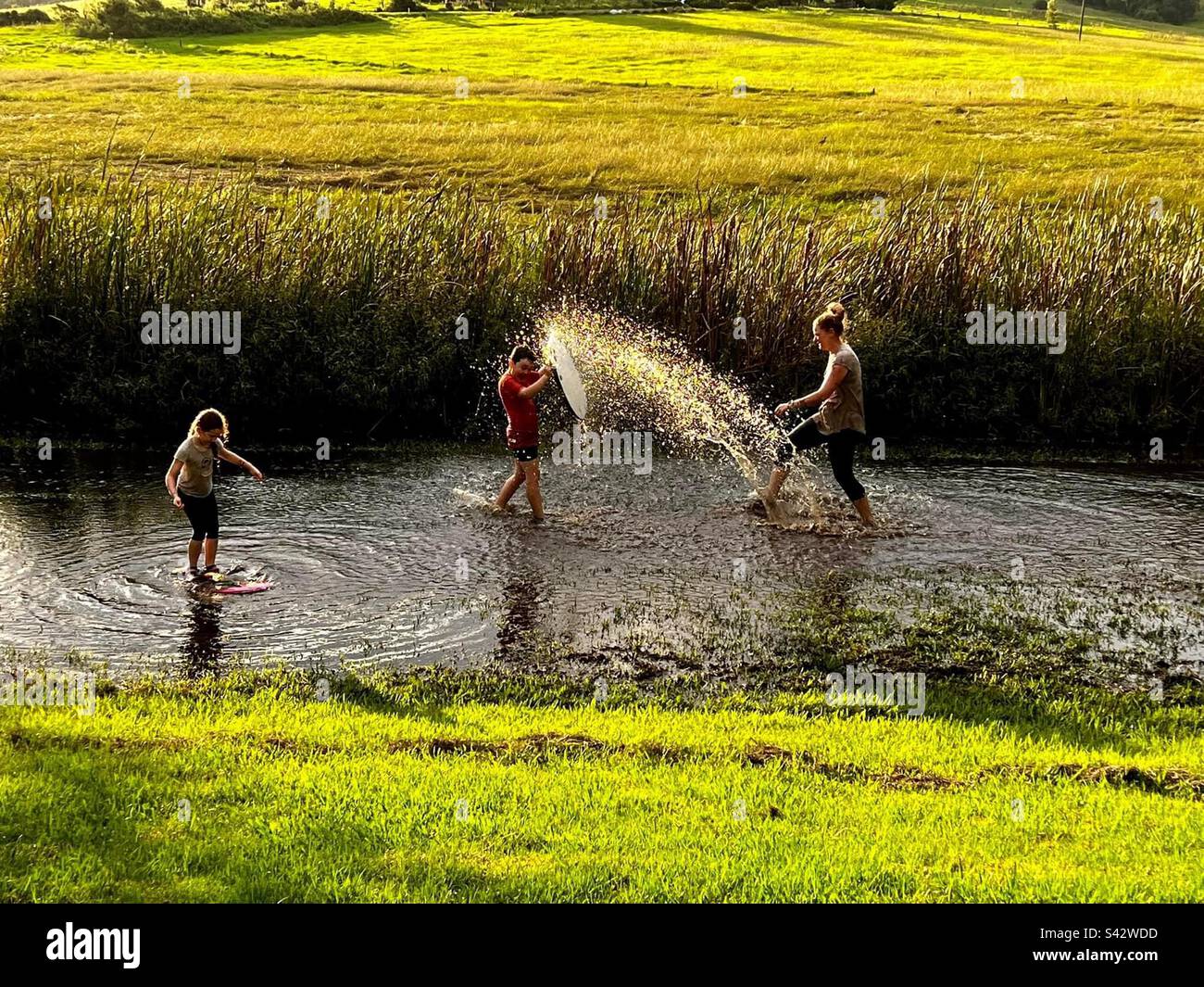 Rural kids playing with water hi-res stock photography and images - Alamy