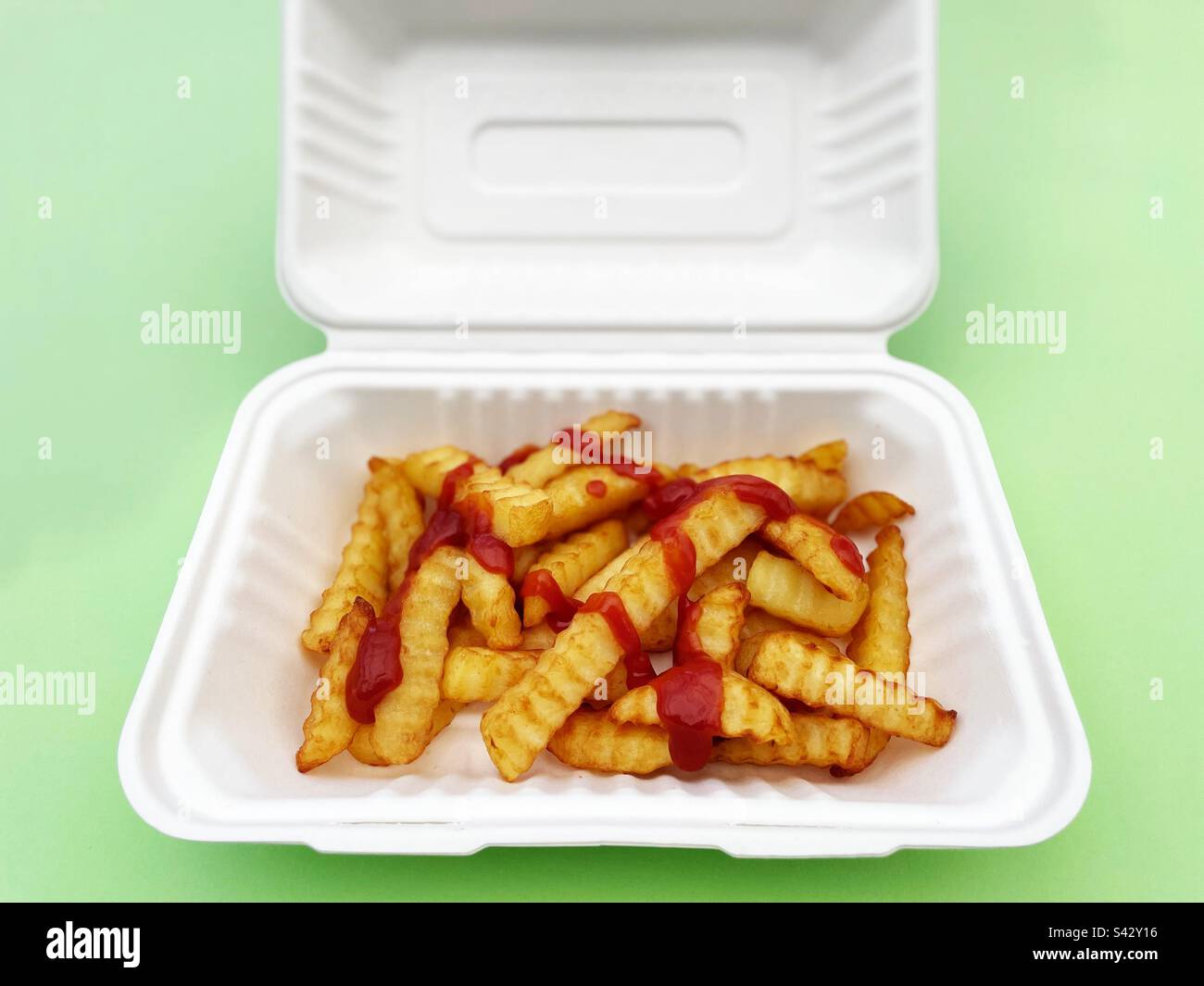 Take away chips with tomato ketchup Stock Photo - Alamy