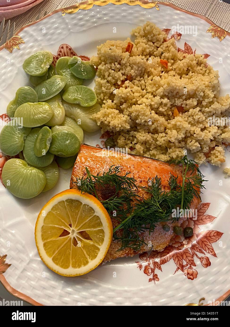 Flap lay of a formal dinner plate filled with salmon fillet, fresh lima ...