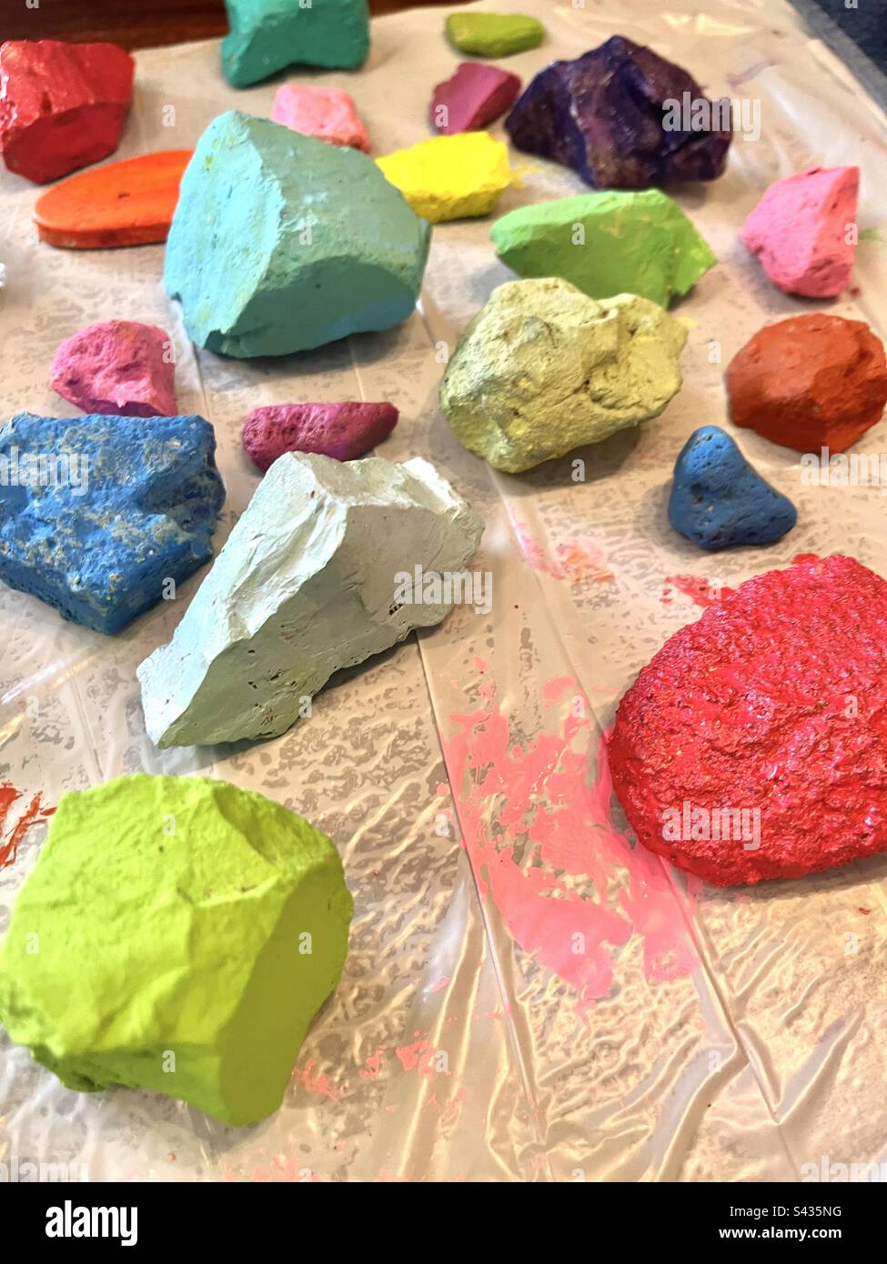 Colorful painted rocks on white background Stock Photo - Alamy