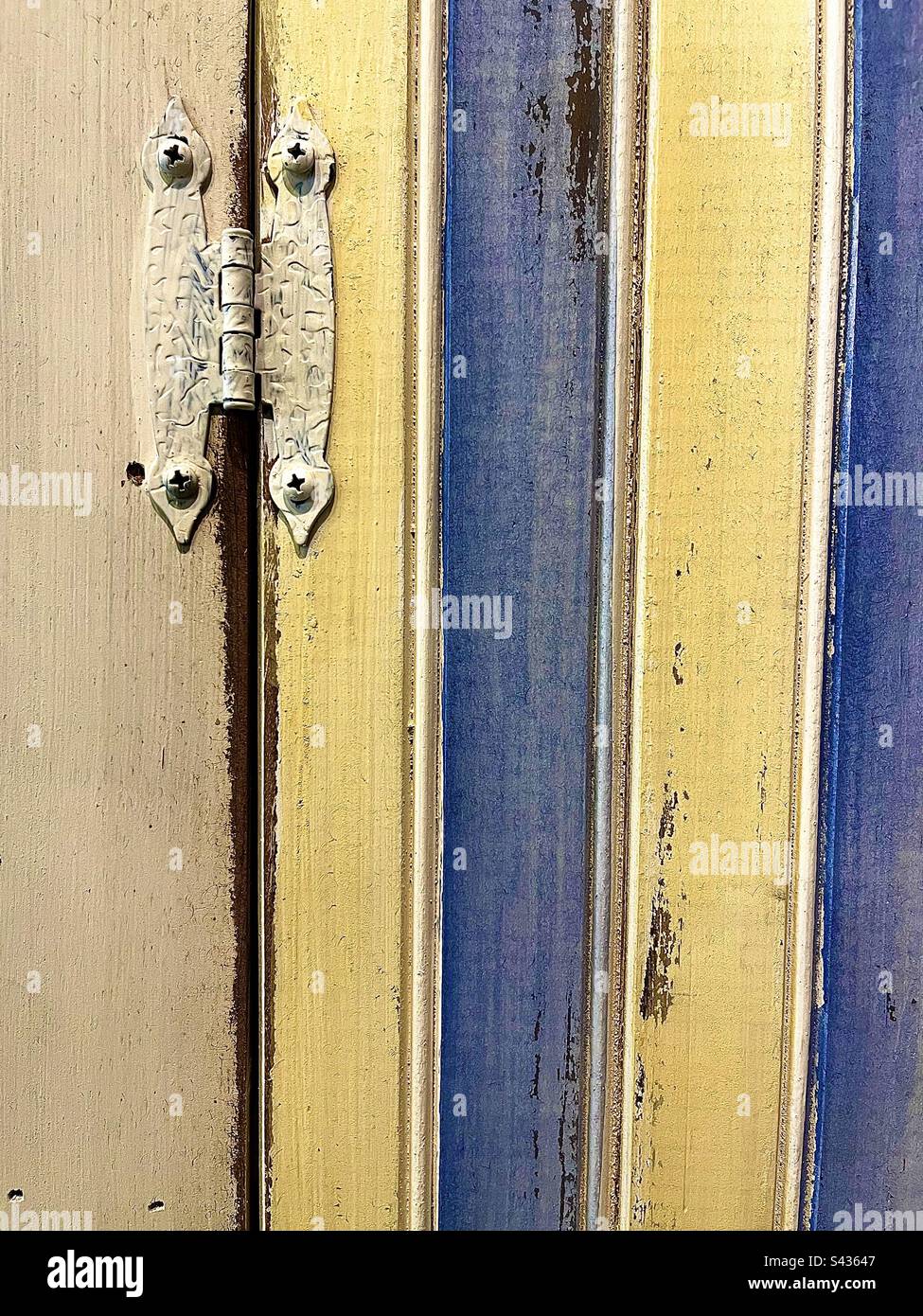 Door hinge and hardware on left with thick yellow and blue pastel ...