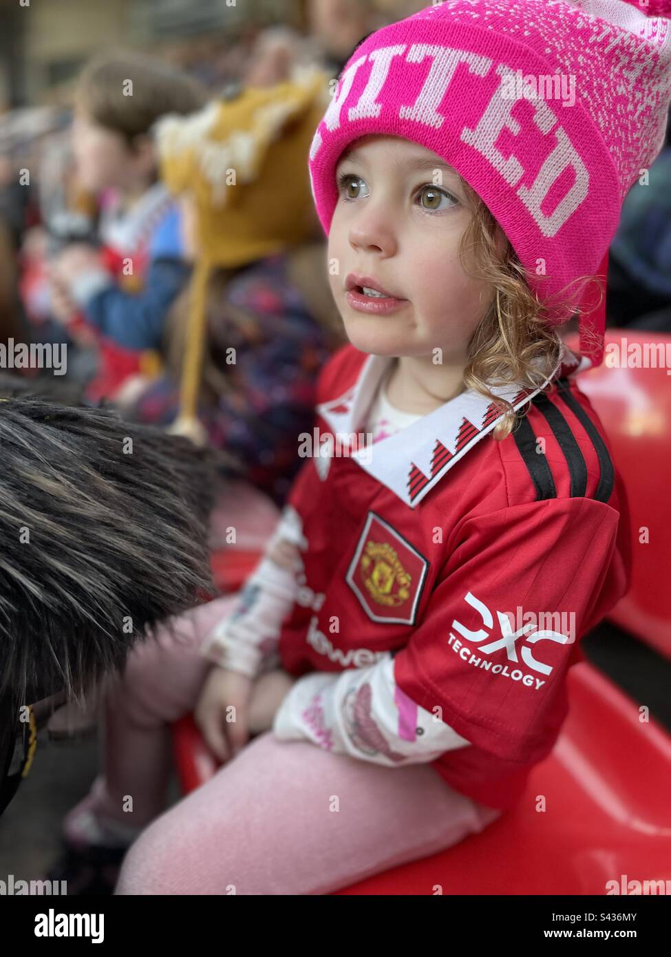 Young Manchester United Women fan watches the match at Old Trafford, 25 ...