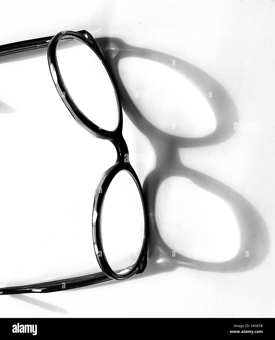 Spectacles and shadow Stock Photo - Alamy