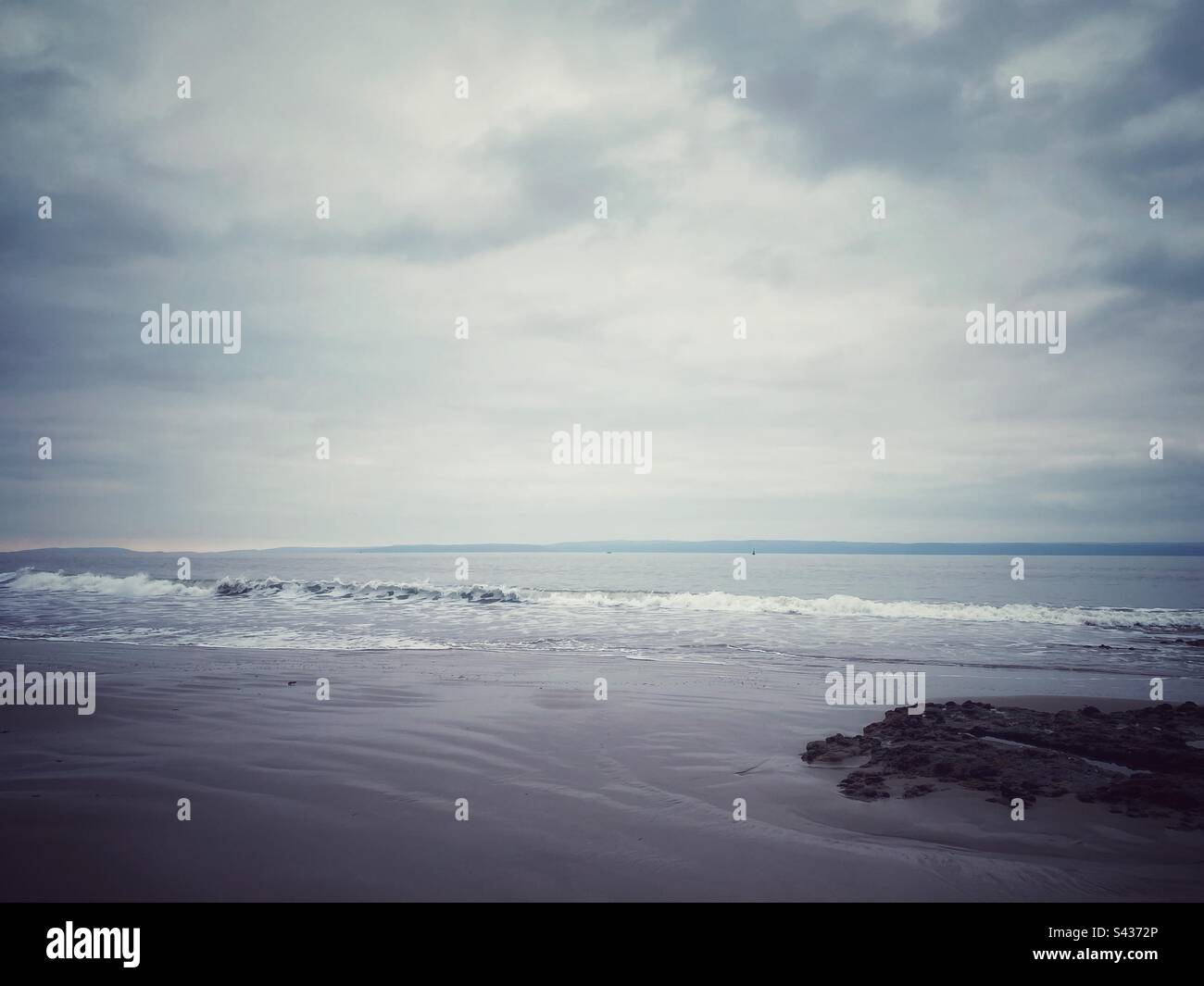 A photograph of a beach scene on an overcast day Stock Photo - Alamy
