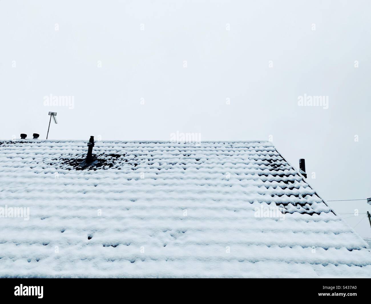 A photograph of a snowy roof of a house Stock Photo - Alamy