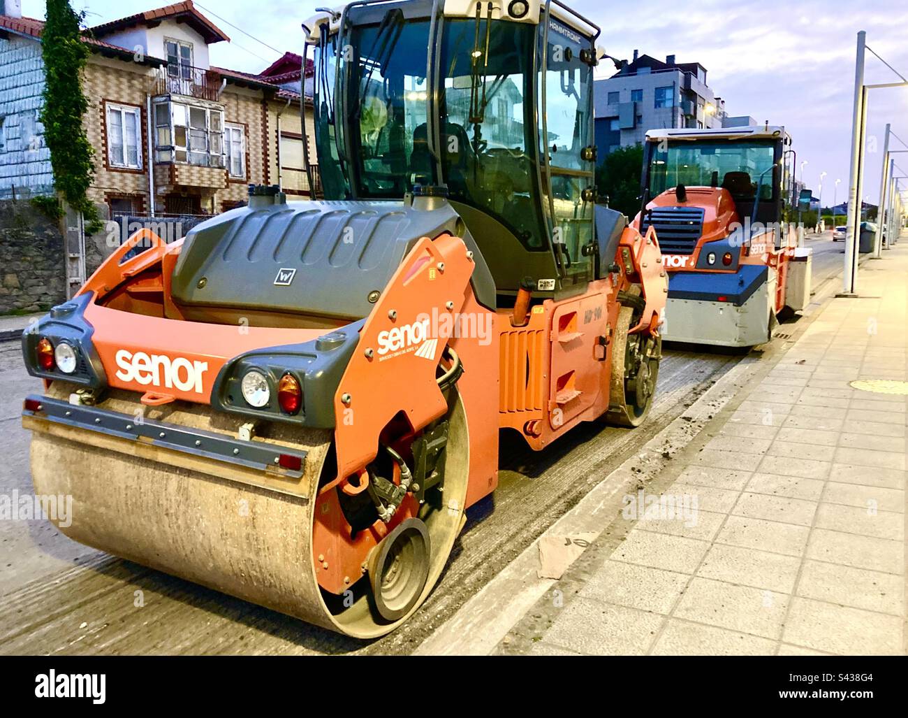 Road roller vehicles parked in a street early morning for road repairs ...