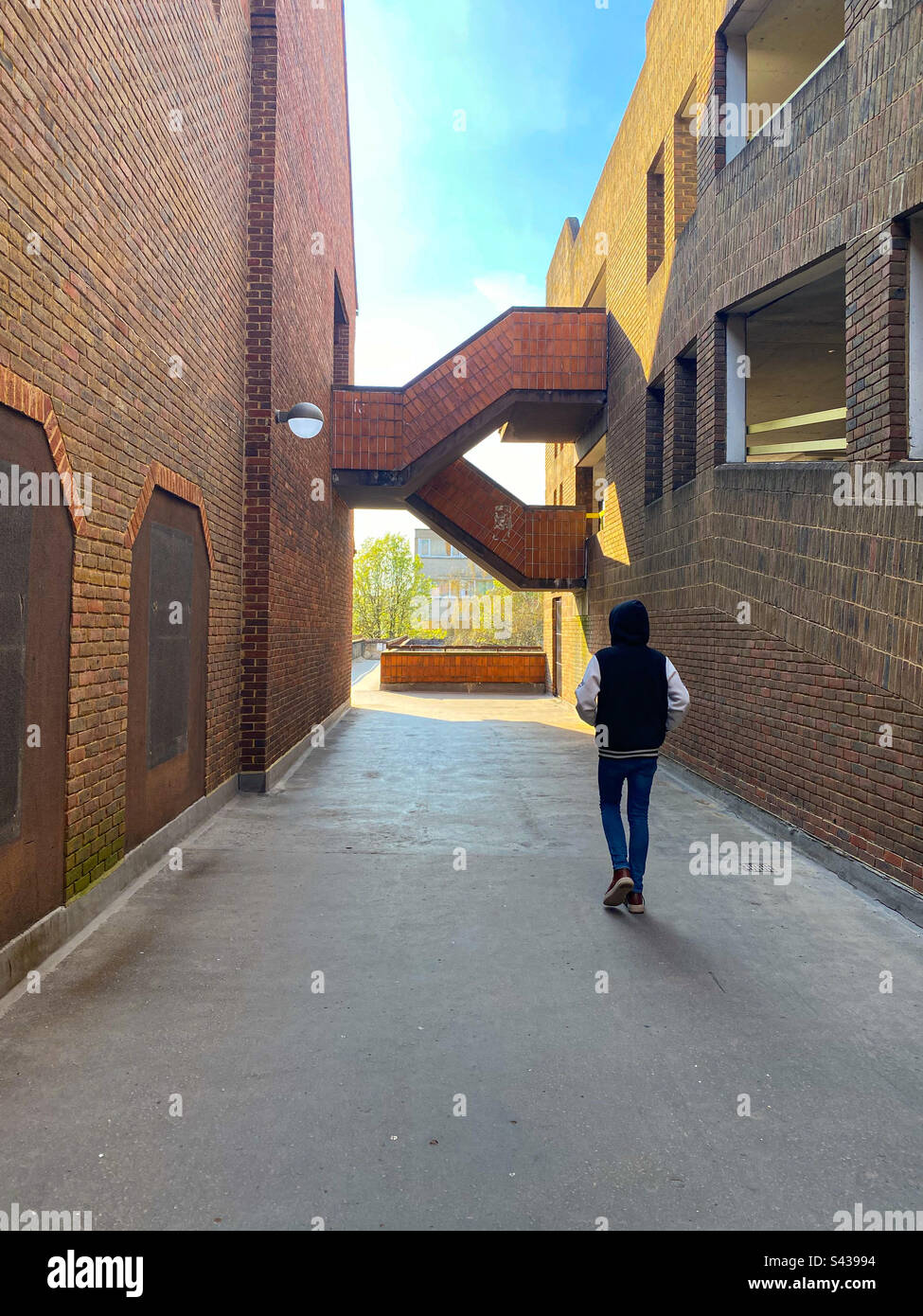 A boy walking along a passageway Stock Photo - Alamy