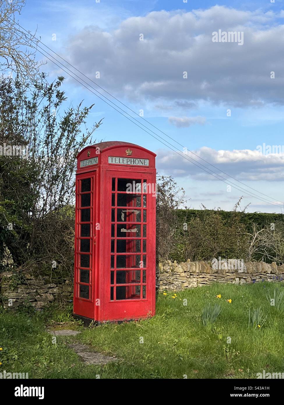 Red telephone box in Cotswold Village Stock Photo - Alamy
