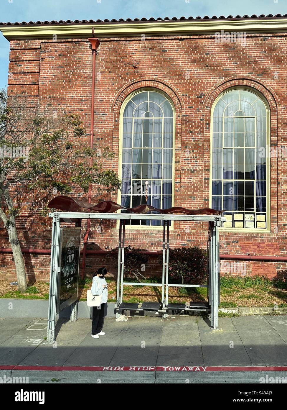 Woman standing bus stop hi-res stock photography and images - Alamy