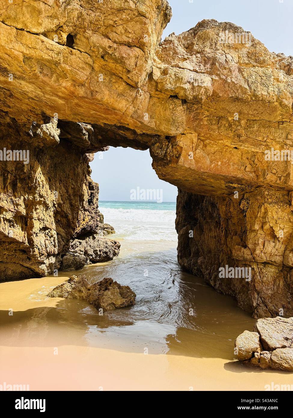 Arch rock formation on the beach at Praia das furnas on the Algarve in ...