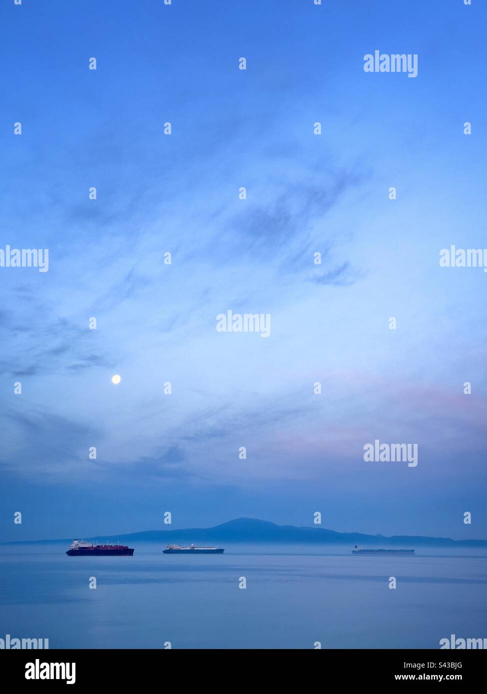 Three boats and a moon in Kalamata Bay Stock Photo - Alamy
