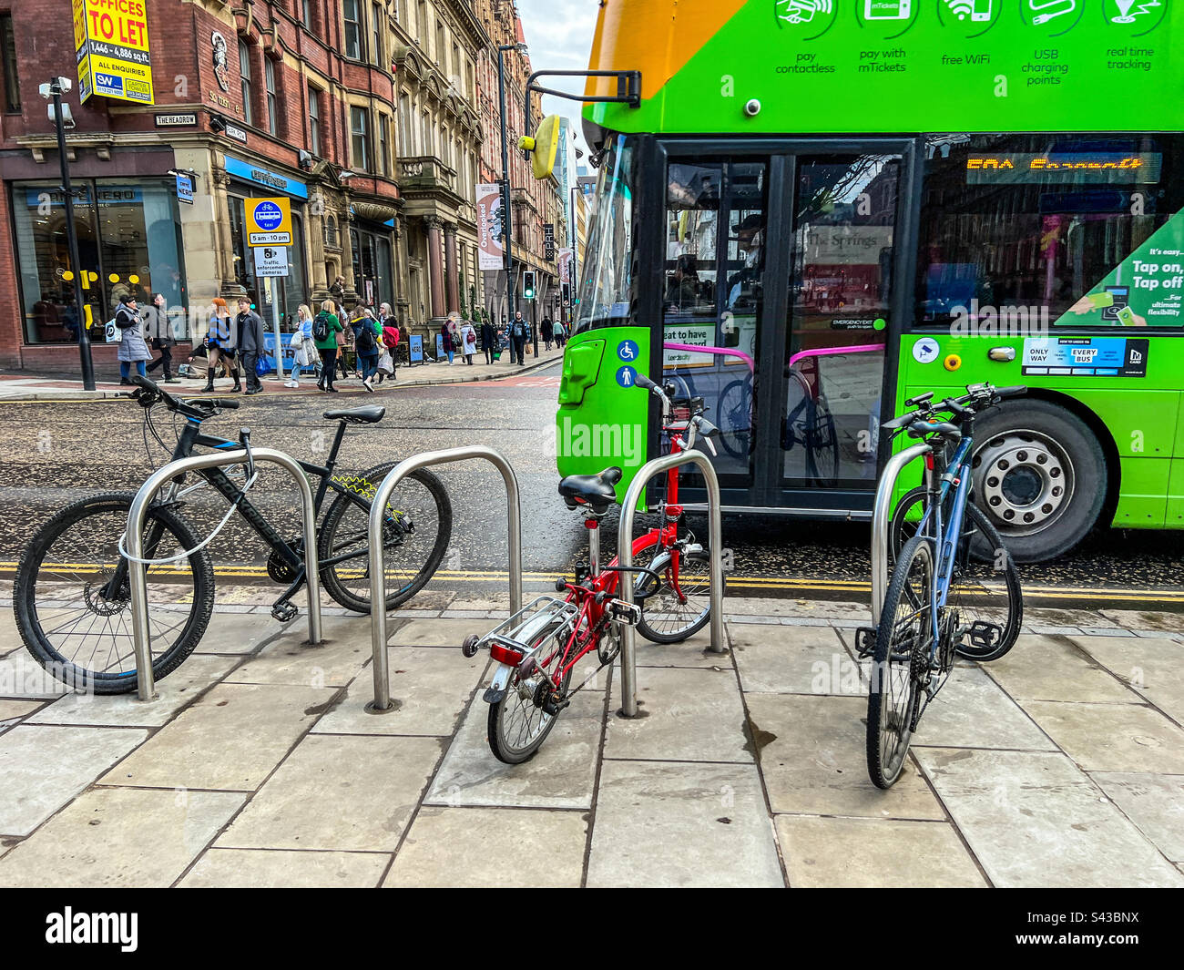 Push bikes and green bus in Leeds City Centre Stock Photo - Alamy