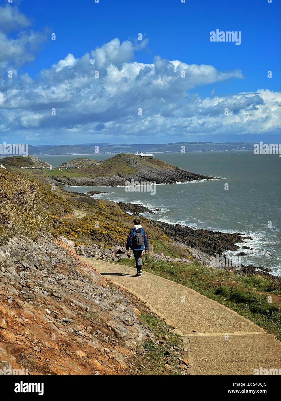 Walker on the Wales coastal path, heading towards Limeslade Bay from ...