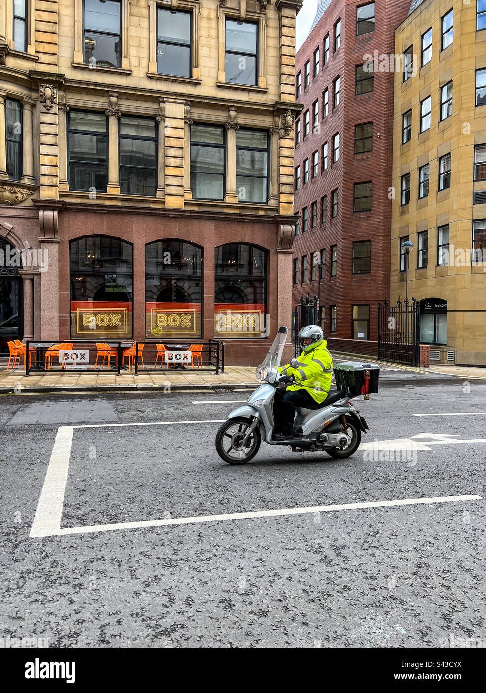 Moped driving in Leeds City Centre Stock Photo - Alamy