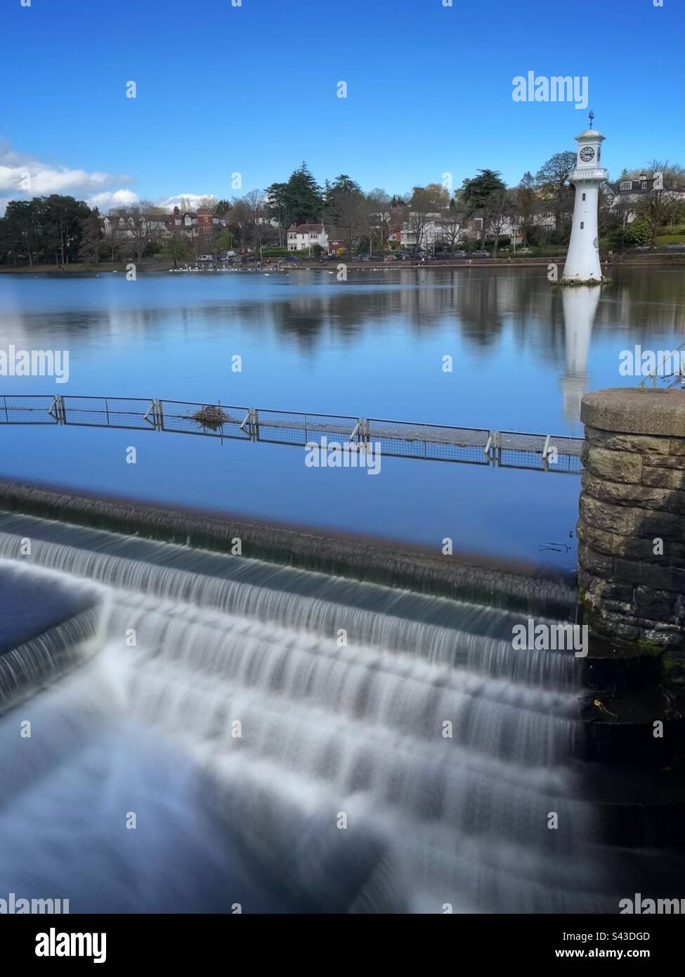 Roath Park, Cardiff, with water flowing over a weir into Roath Brook ...