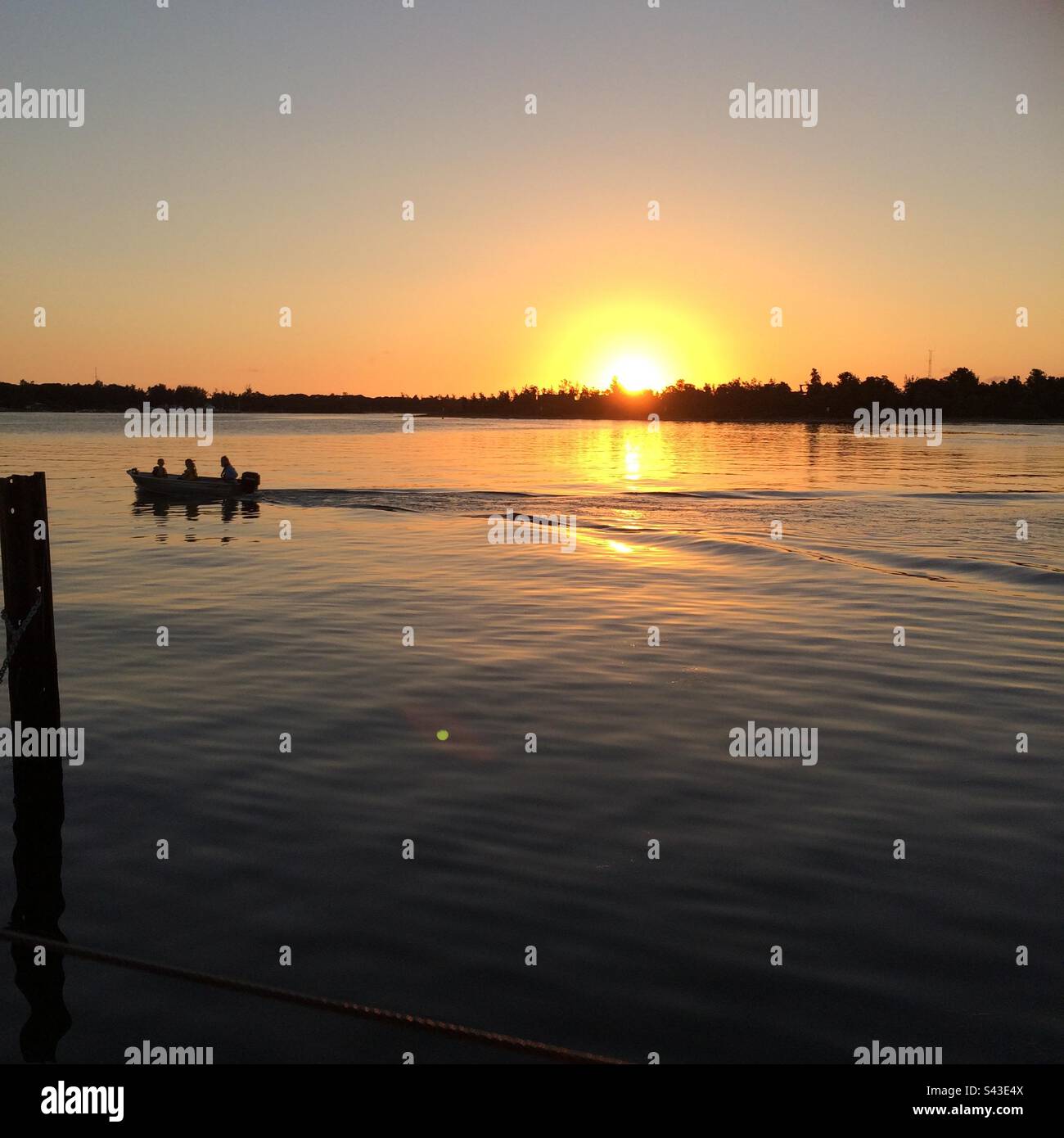 Sunset over the water Stock Photo - Alamy