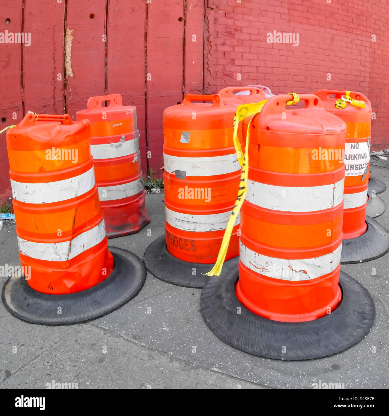 Group of traffic cones in front of a red wall Stock Photo - Alamy
